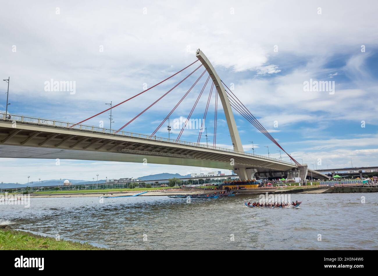 City scenery with competitive boat racing under the bridge Stock Photo ...