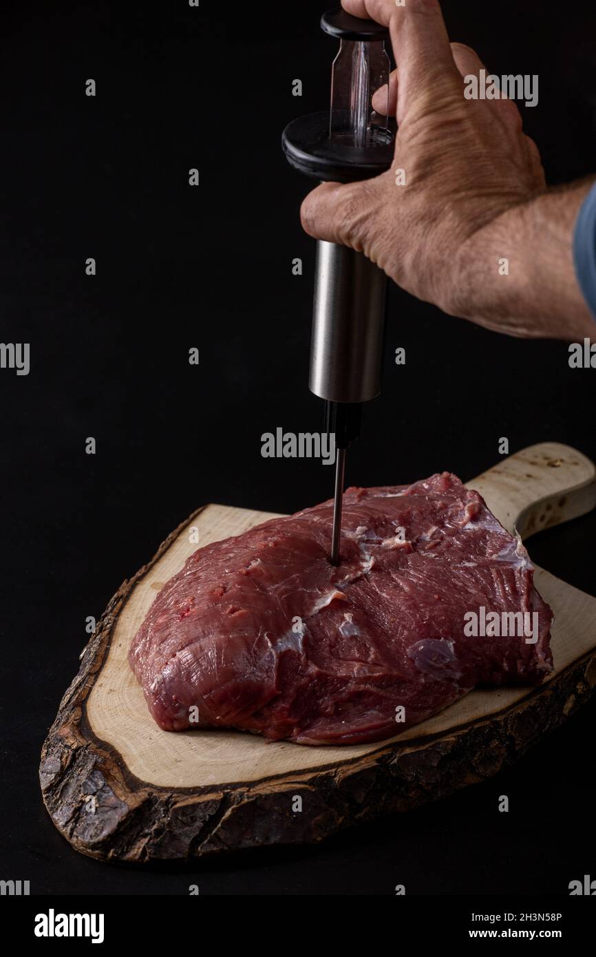 Raw meat on wooden chopping board Stock Photo - Alamy