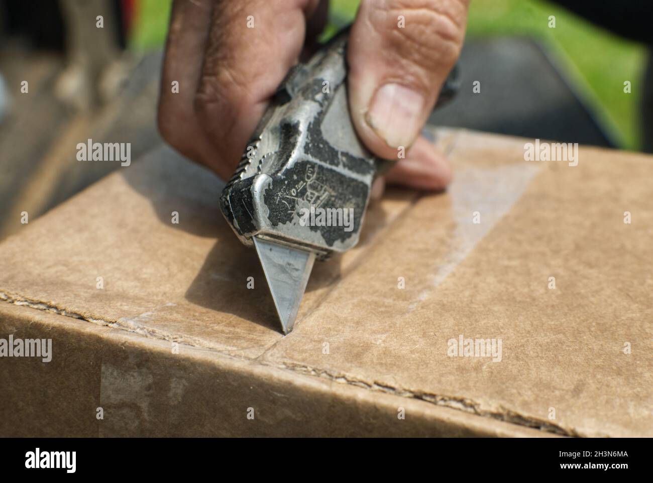 Cutting open a box hi-res stock photography and images - Alamy