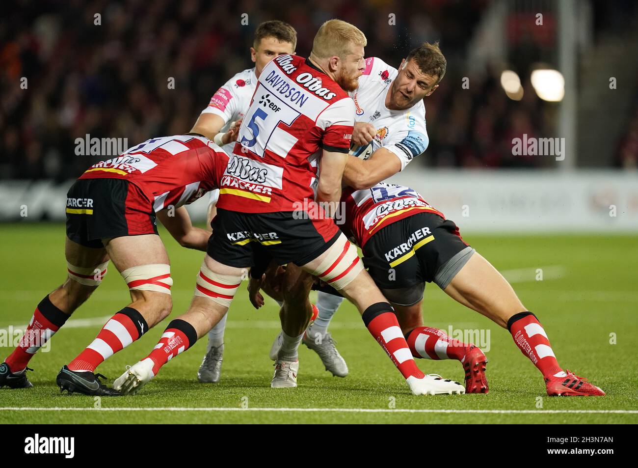 Exeter Chiefs' Ollie Devoto is tackled by Gloucester Rugby's Andrew ...