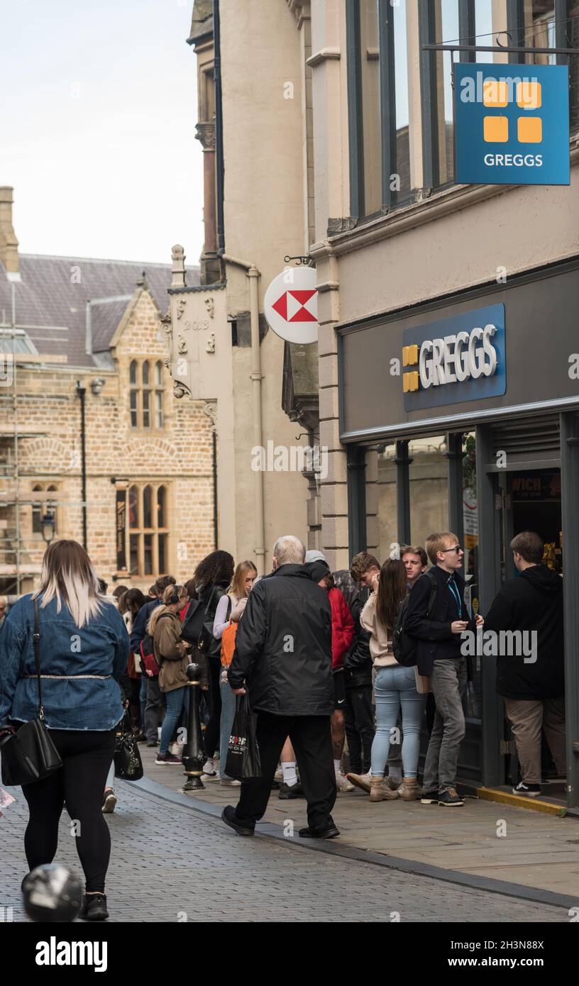 People queuing up outside the Greggs bakery shop in the town of Durham ...
