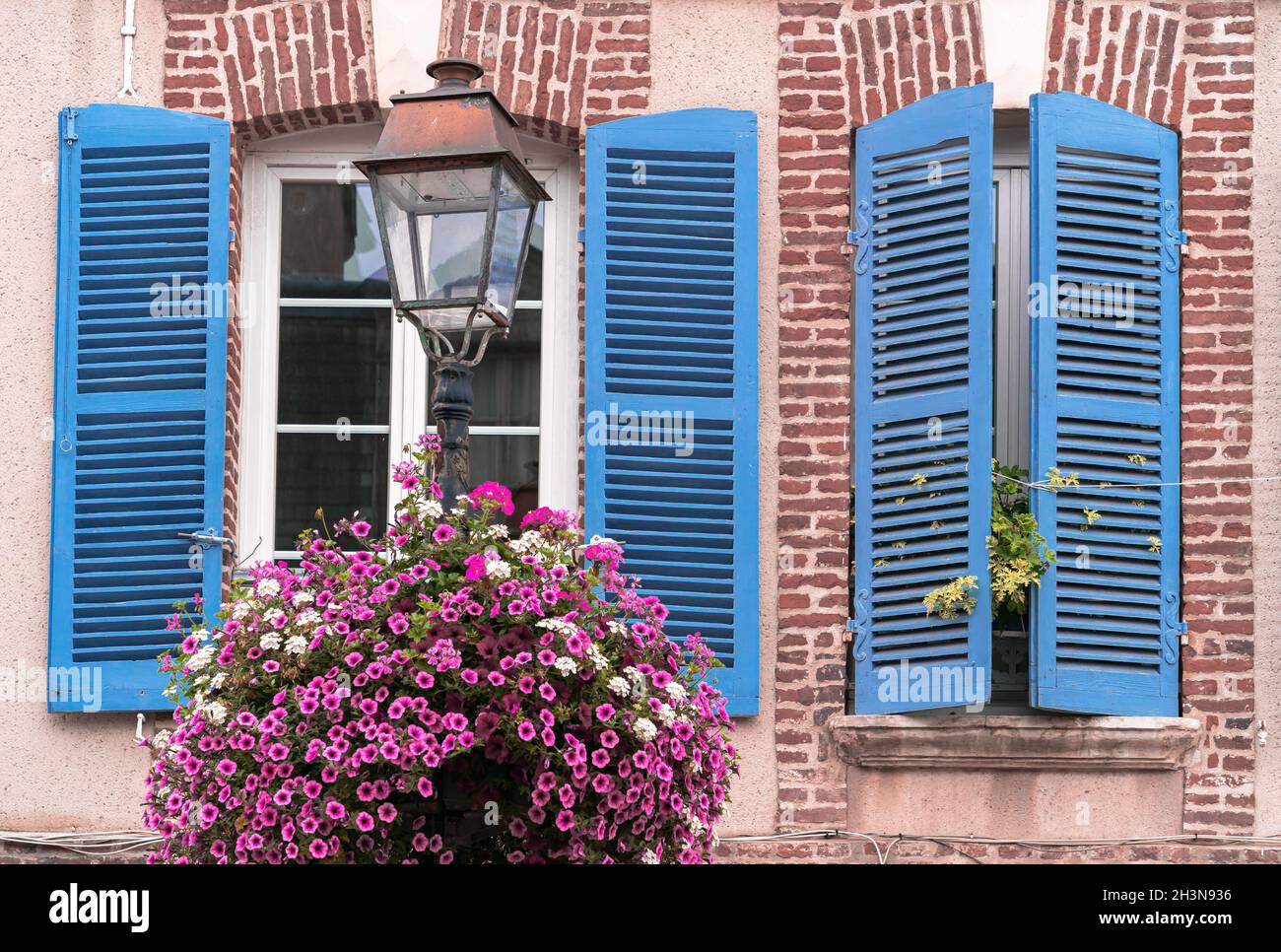 Windows of a french brick house in Honfleur, Normandy, with blue wooden ...