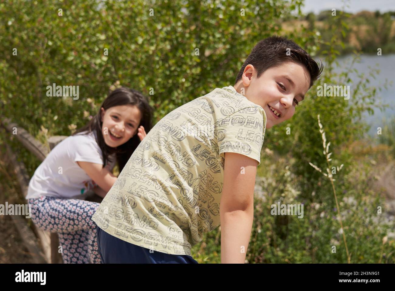 Children playing park fence hi-res stock photography and images - Alamy