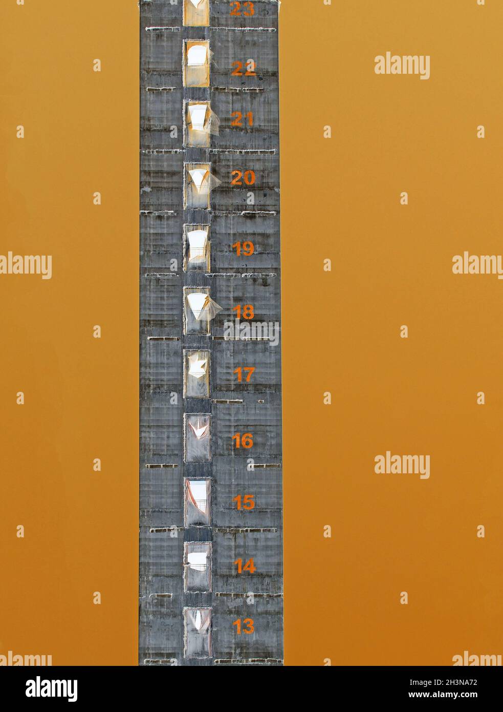 Color negative image of a tall concrete tower under construction with ...