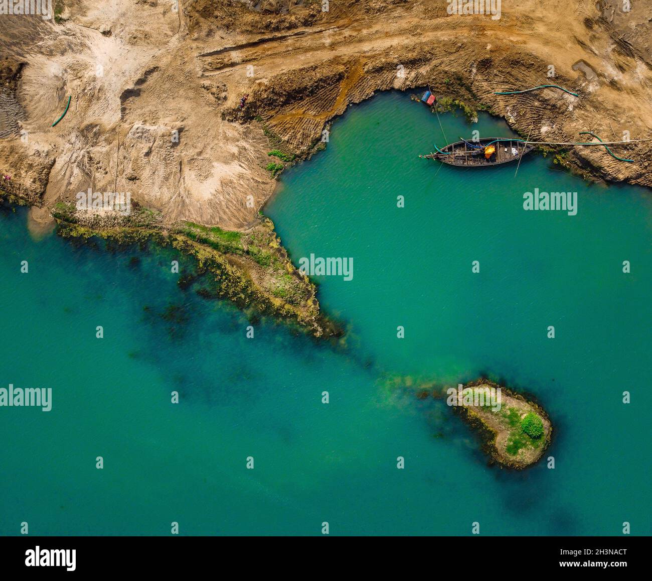 Aerial view of a geological formation in the sea and a boat near it ...