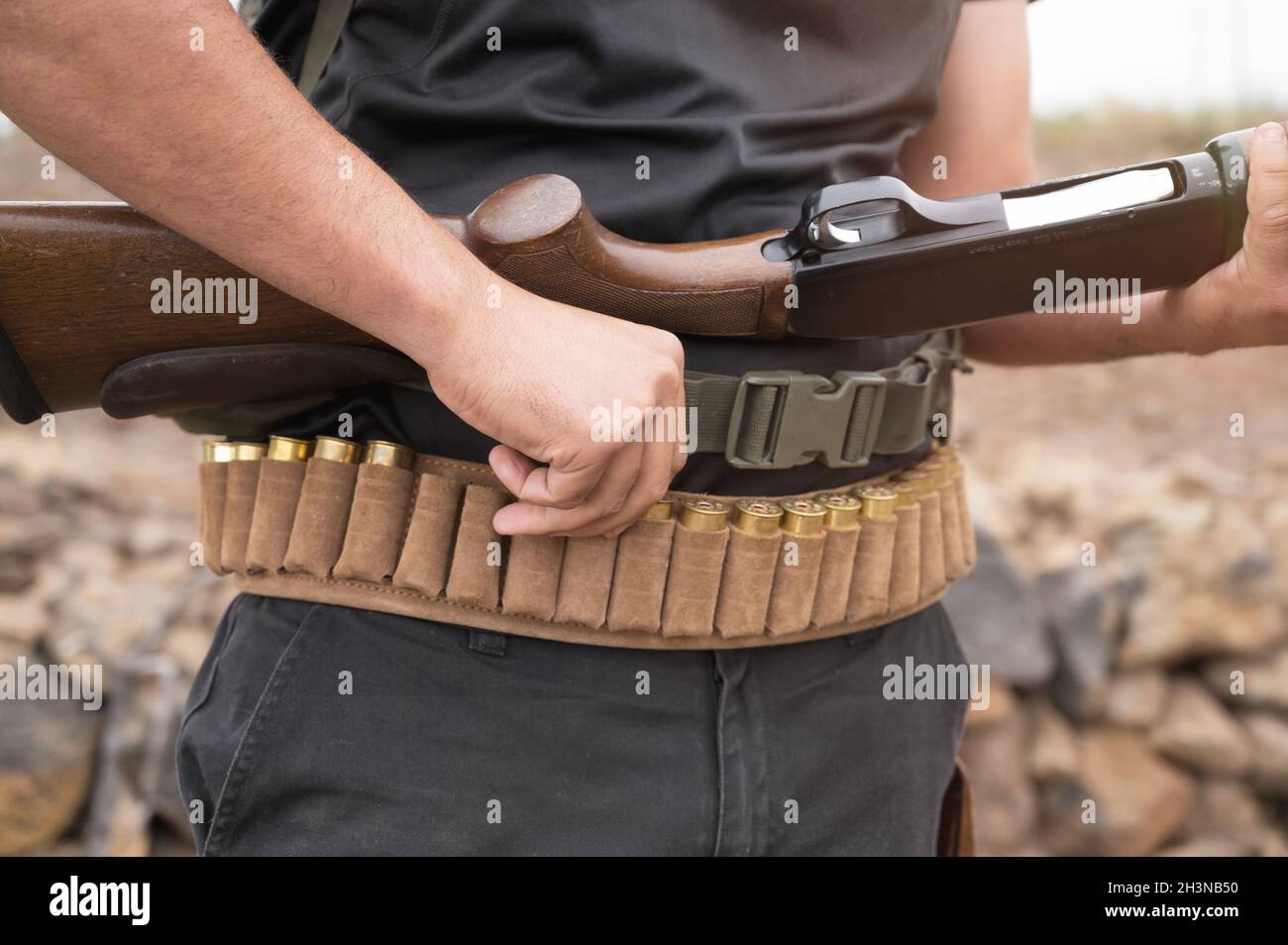 Close up of an unrecognizable hunter, loading shotgun, holds a shotgun ...