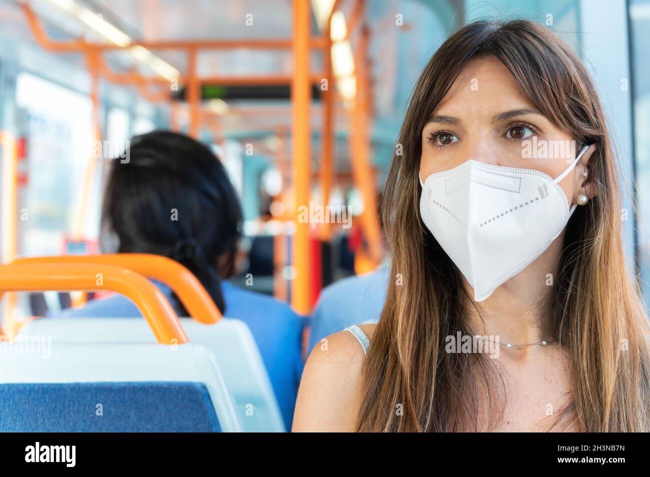 Woman with face mask traveling by tram during Covid-19 outbreak Stock ...