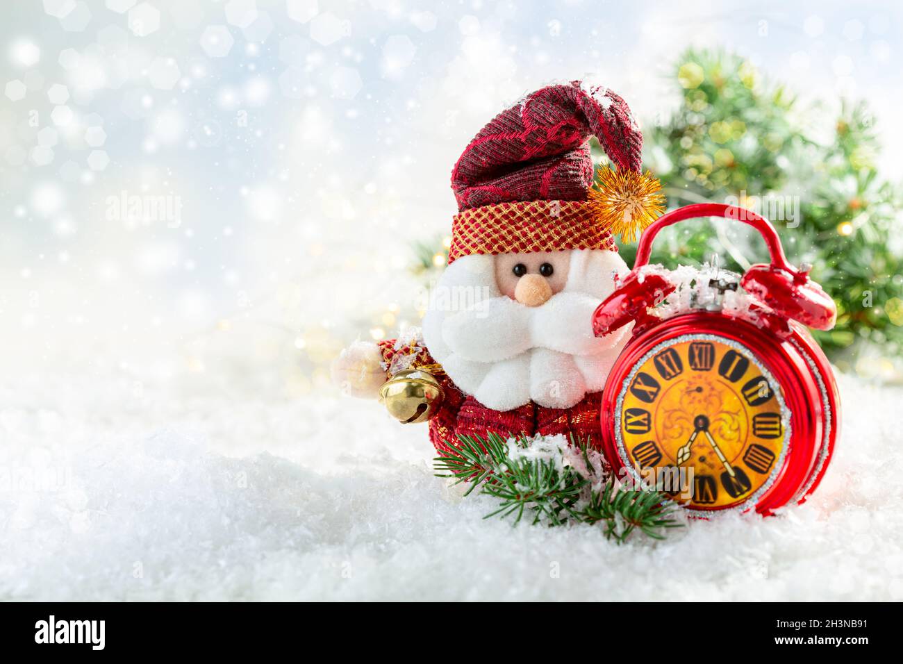 Santa Claus with a bell and a red alarm clock Stock Photo - Alamy