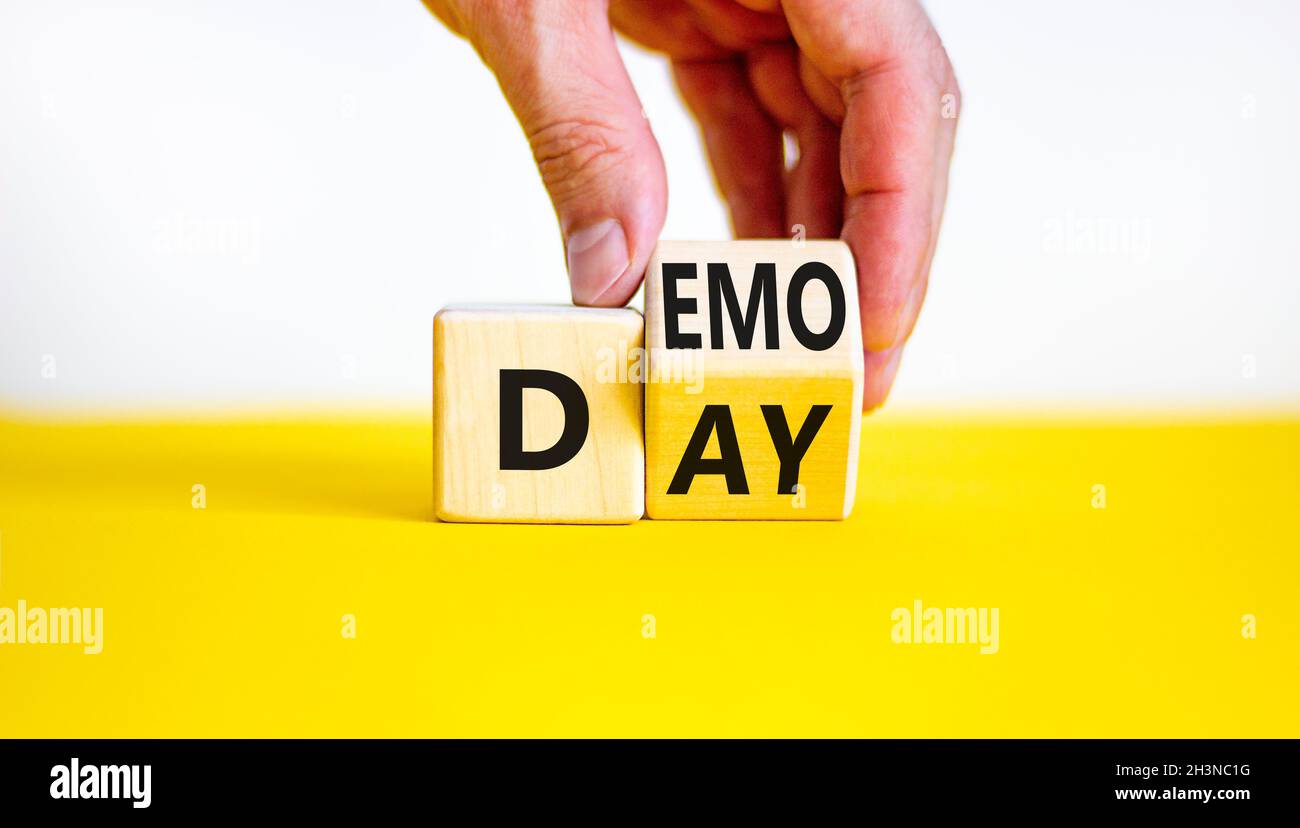 Demo day symbol. Businessman turns a wooden cube with concept words ...