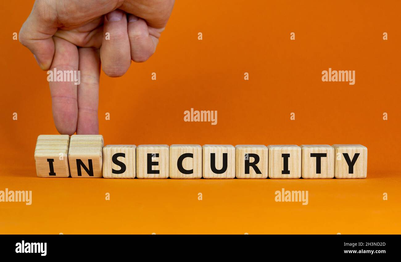 Security or insecurity symbol. Businessman turns wooden cubes, changes ...