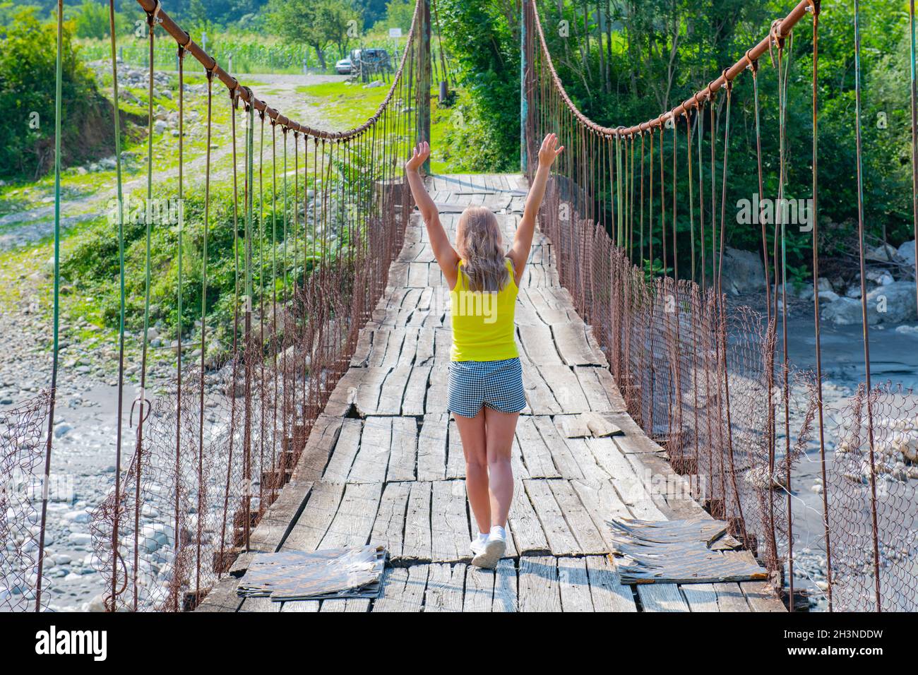 Girl on suspension bridge hi-res stock photography and images - Alamy