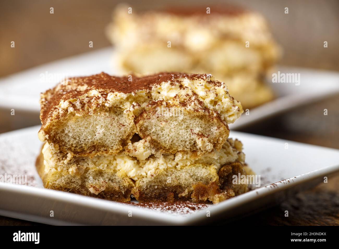 Tiramisu on white plates Stock Photo - Alamy