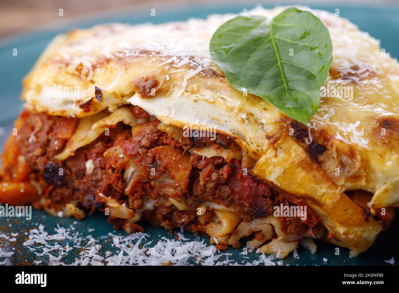 Portion of fresh lasagna on a blue plate hi-res stock photography and ...