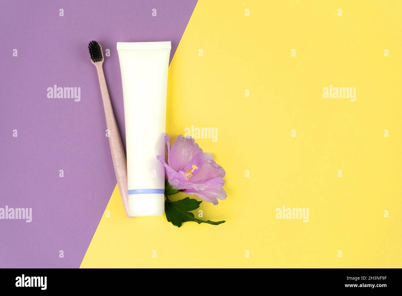 Tube of toothpaste with a toothbrush made of recycled plastic with ...