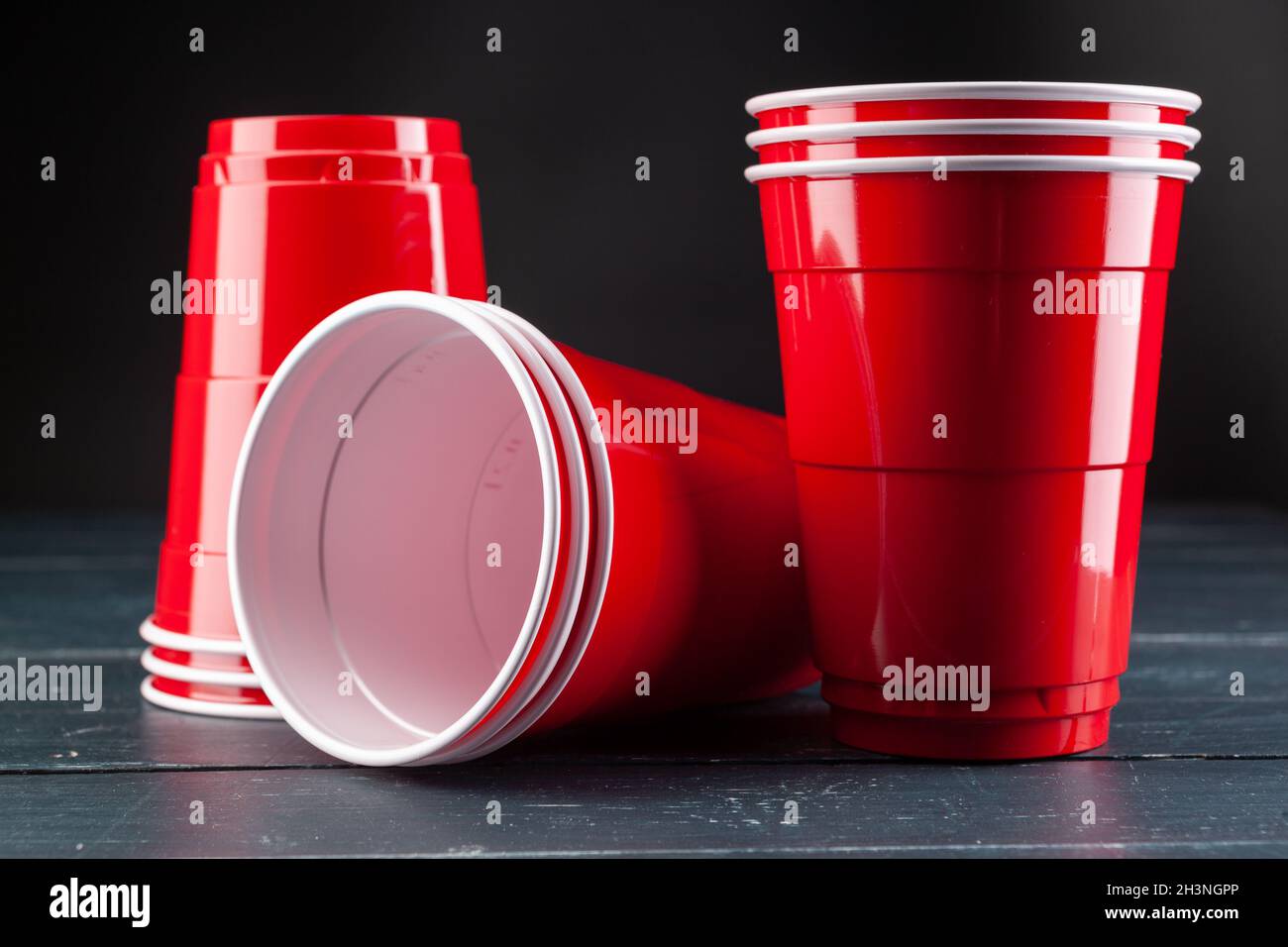 Wooden table with red cups and ball for beer pong Stock Photo - Alamy