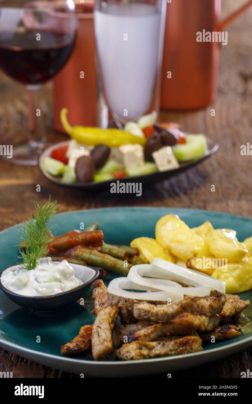 Greek gyros with french fries on wood Stock Photo - Alamy