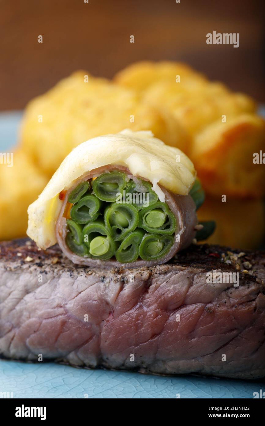 Slice of steak on a blue plate Stock Photo - Alamy