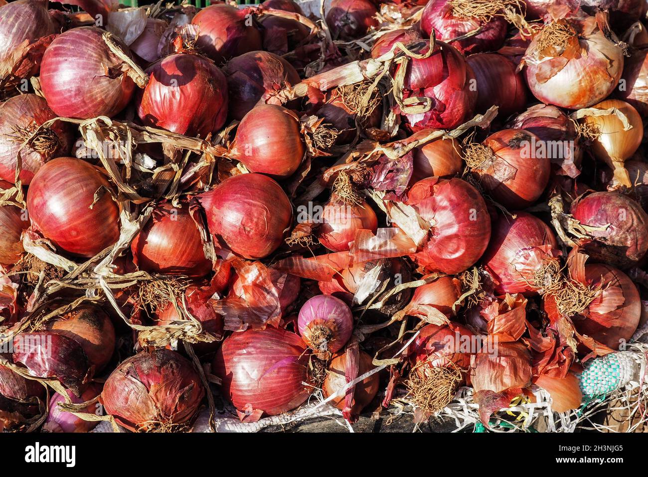 Top view detail - sun shines to red onions displayed on food market in ...