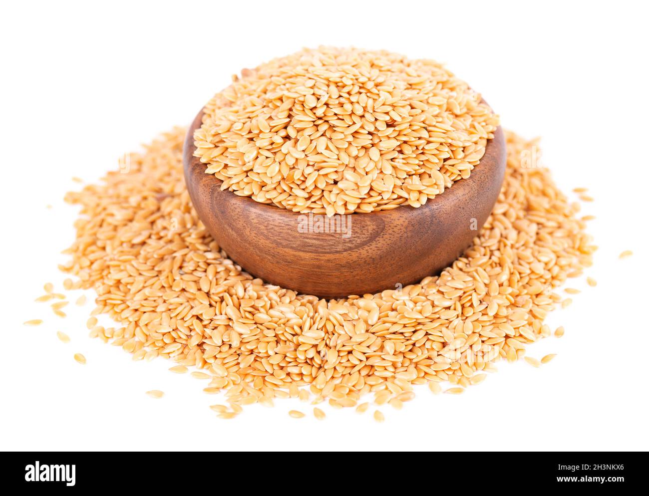 Golden flax seeds in wooden bowl, isolated on white background. Heap of dry flaxseed or linseed ...