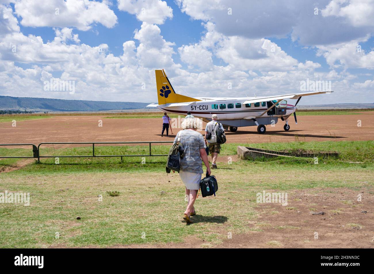 Tourists walk to a Mombasa Air Services Cessna Caravan 208B aircraft at ...