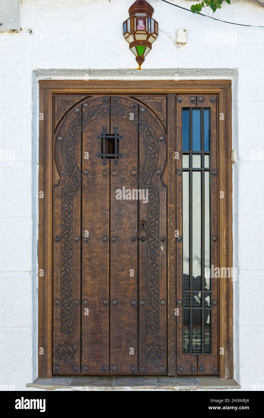 Rustic, wooden door decorated with Mudejar motifs and geometric ...