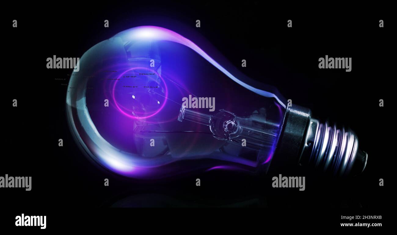 Digitally generated image of glowing purple light bulb against black ...