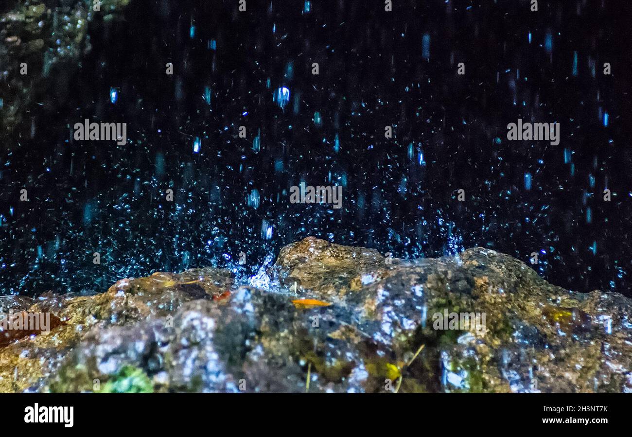 Water flows through rocks in the cave. A small waterfall at the ...