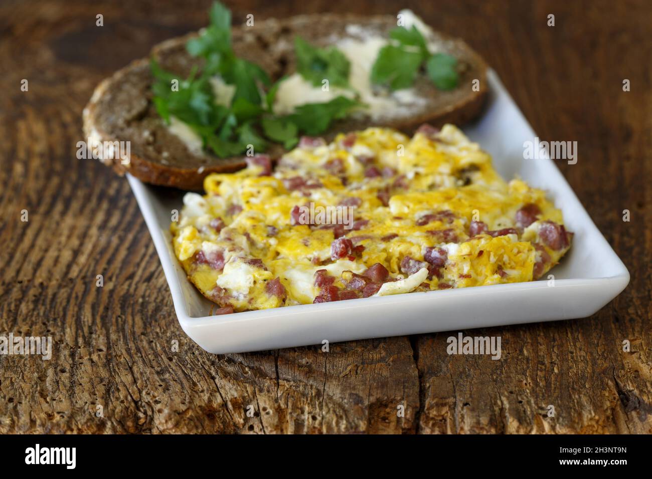 Scrambled eggs on a white plate Stock Photo - Alamy