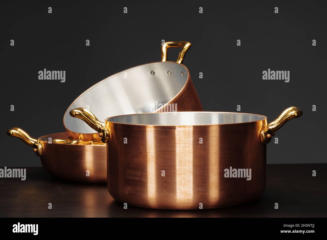 Set of copper cookware over dark background Stock Photo - Alamy
