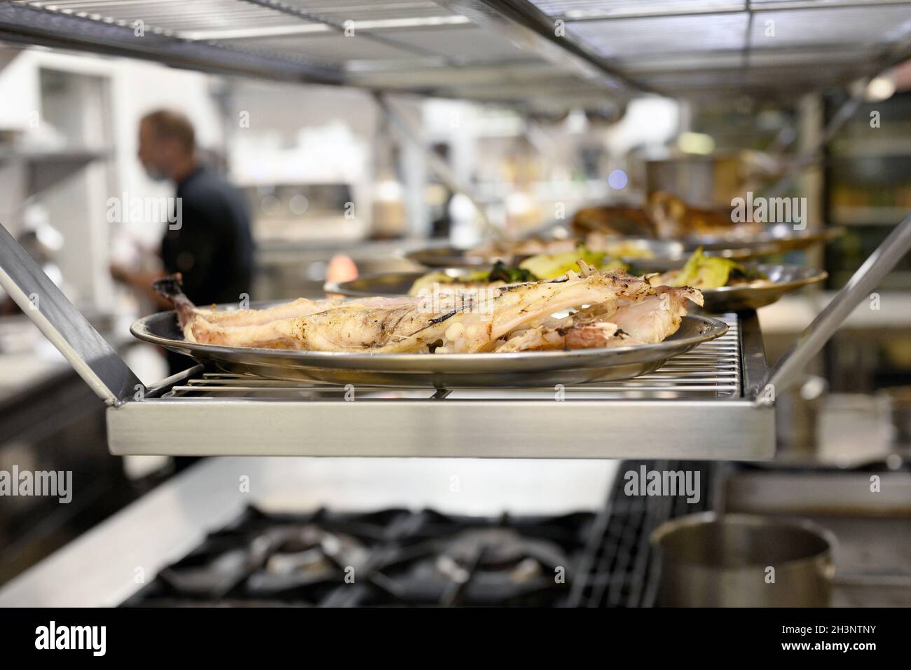 Food being cooked in commercial stainless steel kitchen in restaurant ...