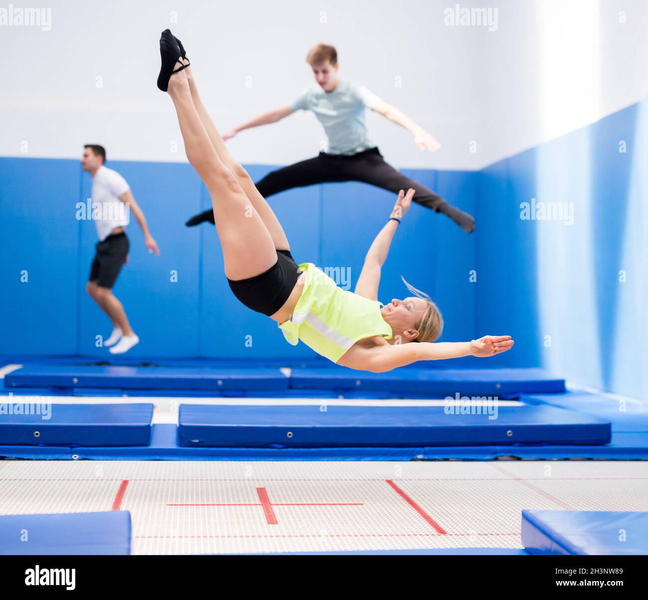 Female gymnast jumping on trampoline Stock Photo - Alamy