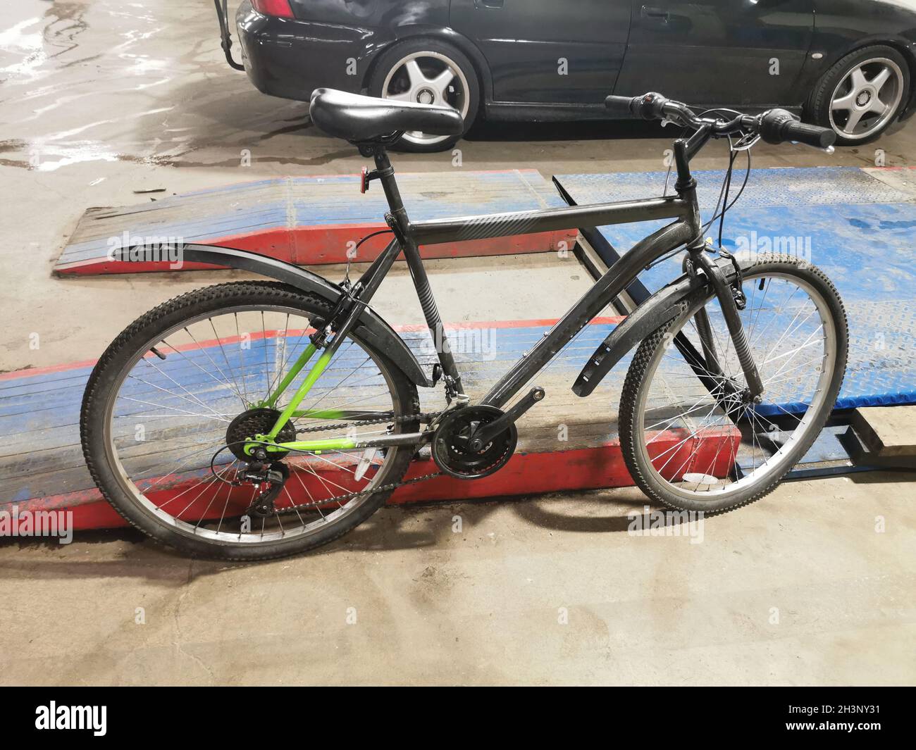 A black bicycle in a car repairing retail shop Stock Photo - Alamy