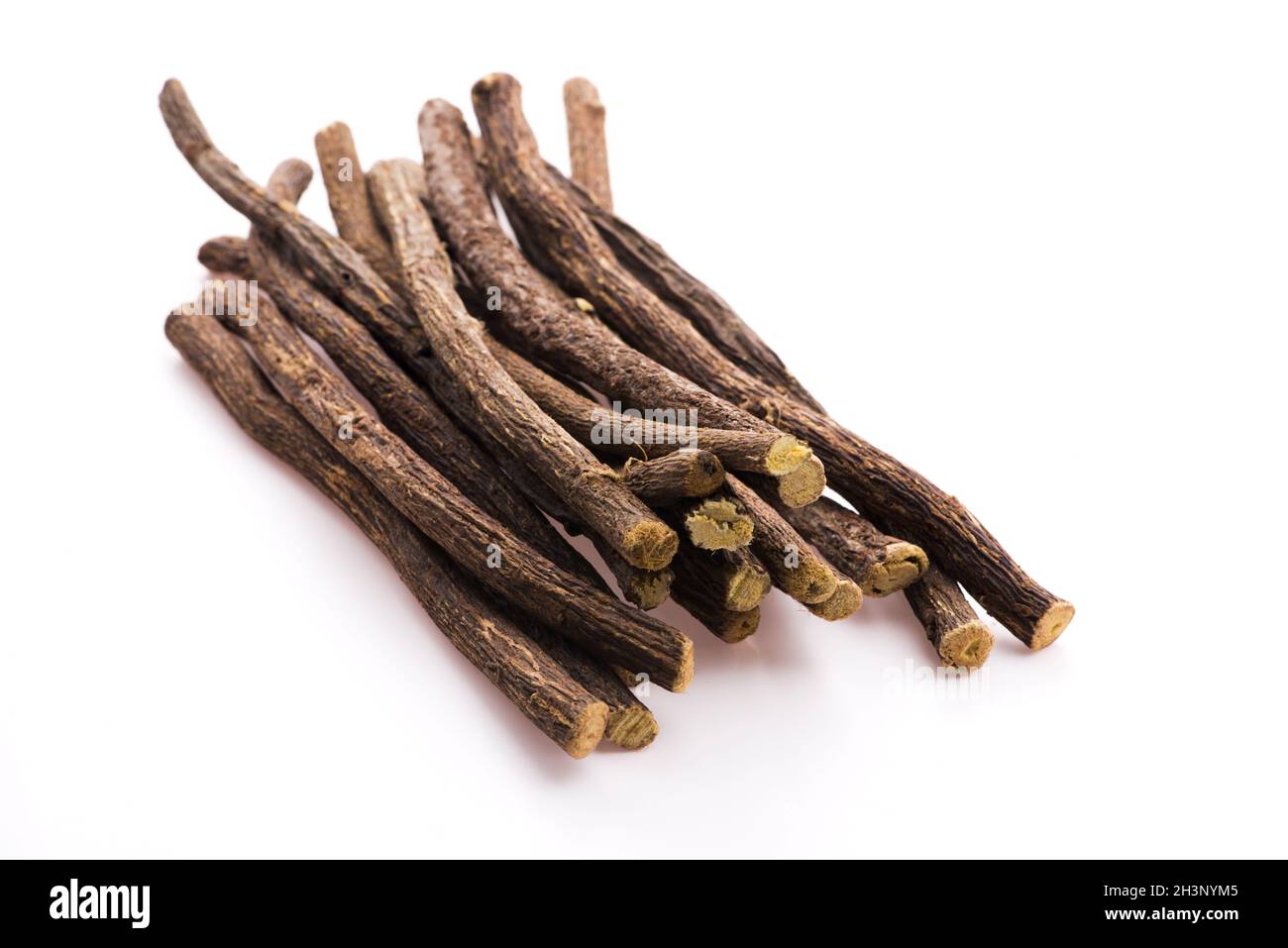 Licorice roots on white background Stock Photo - Alamy