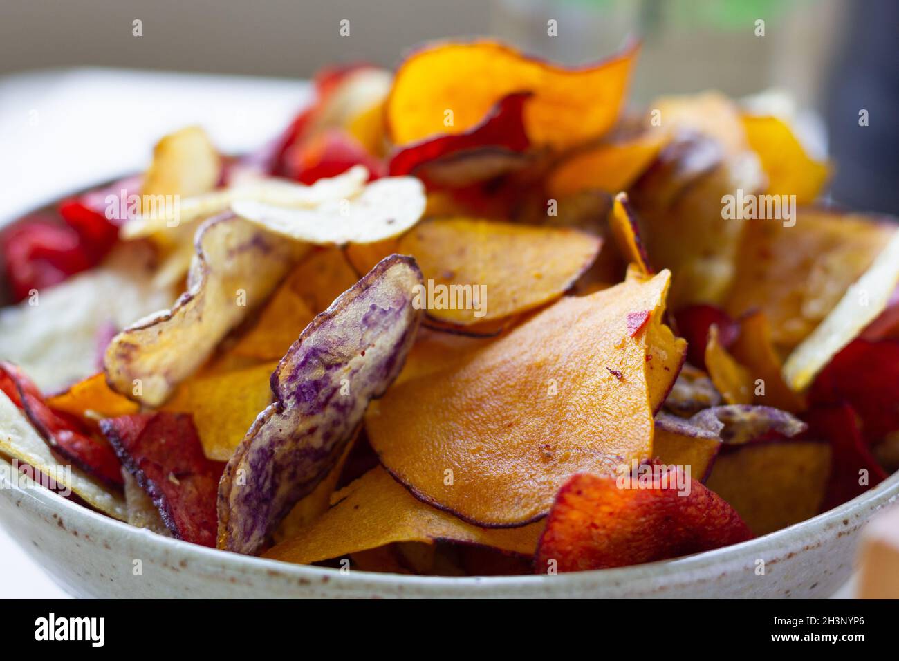 Variety of colorful potato chips in bowl. Healthy snack concept Stock ...