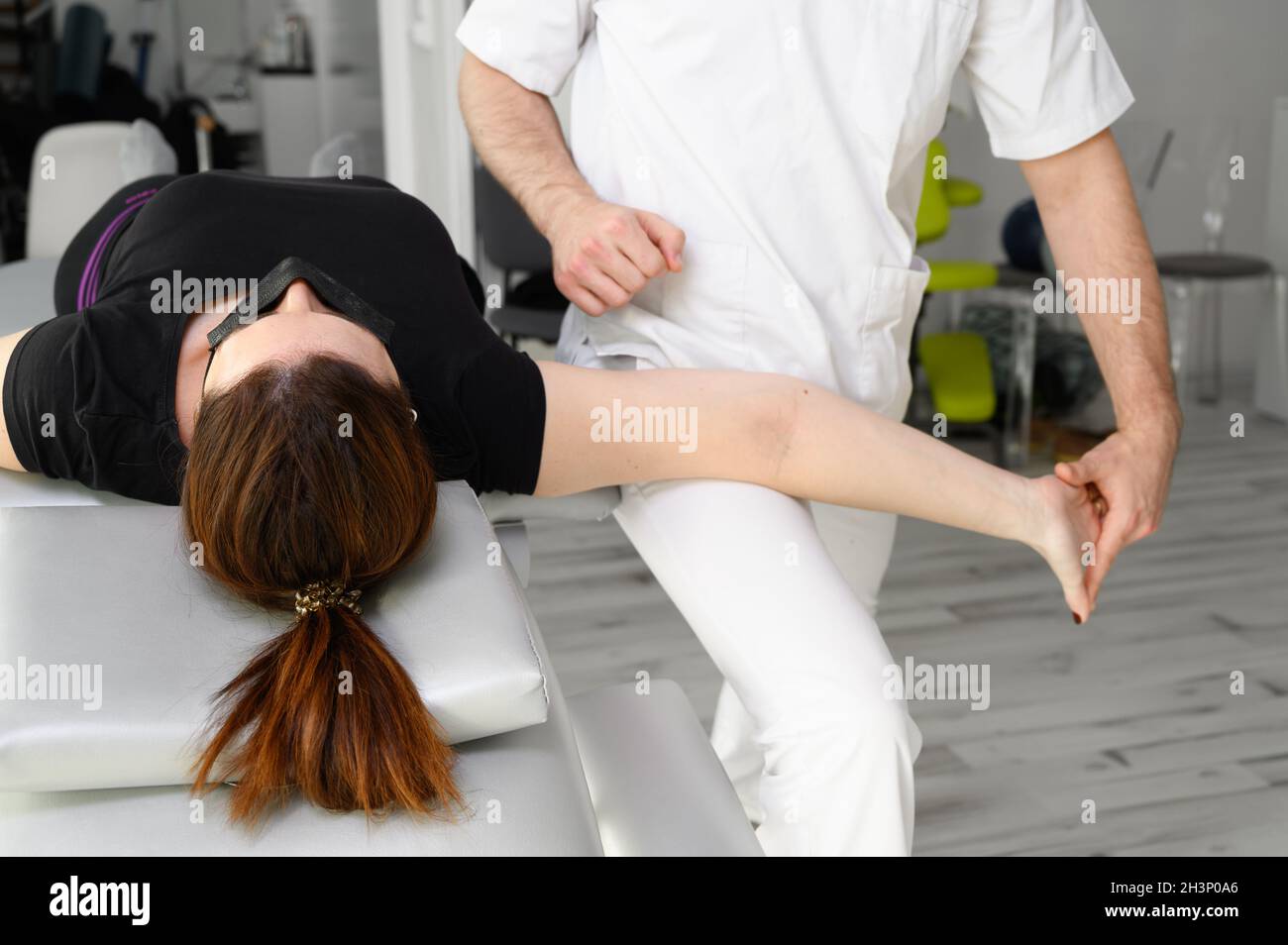 Male therapist giving massage to relief shoulder pain to a female ...