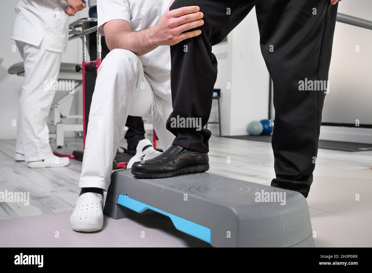 Senior Patient and physical therapist in rehabilitation walking ...