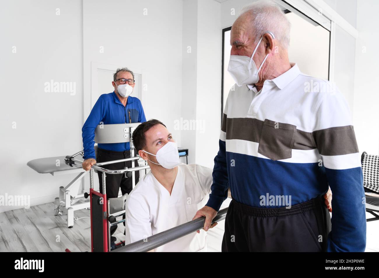 Group of Physical therapists working in rehab center, helping patients ...