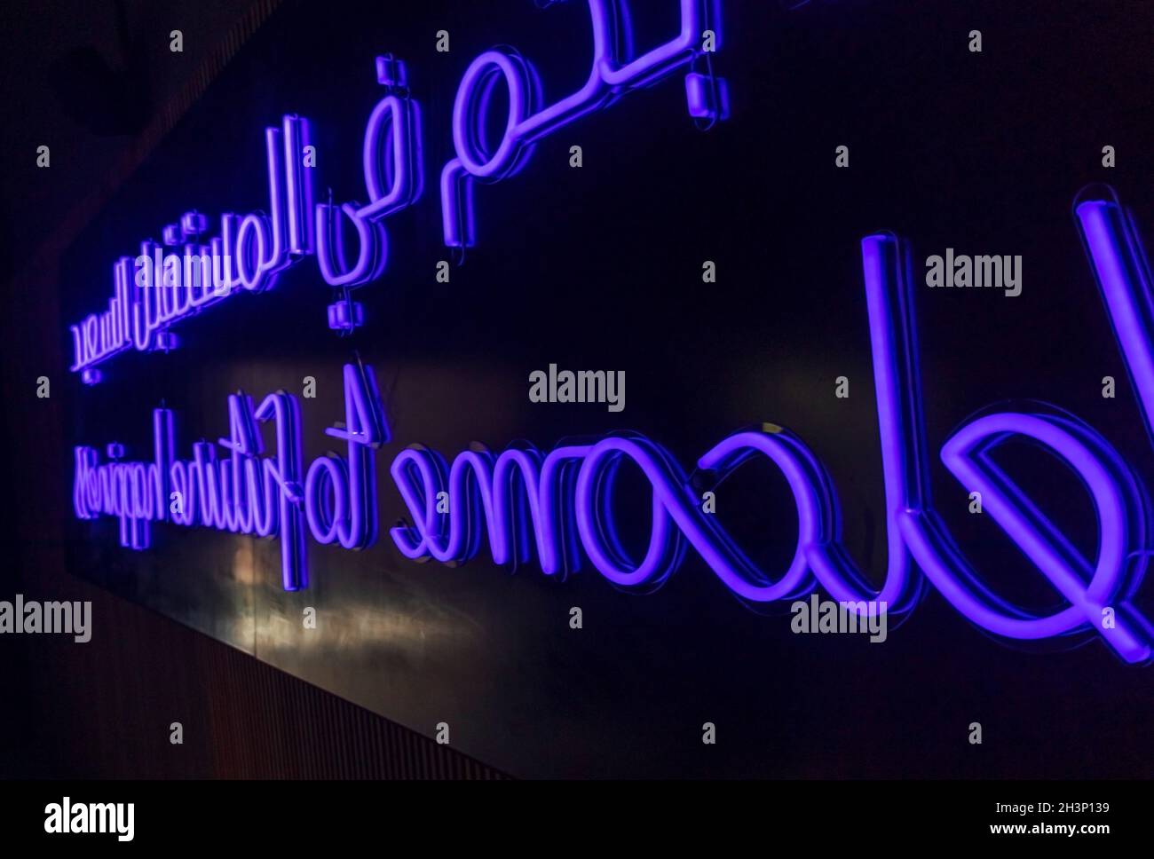 Shot of a neon signage in English and Arabic languages Stock Photo - Alamy