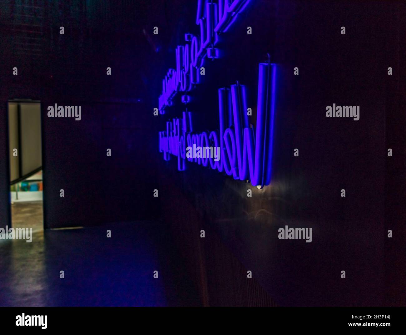Shot of a neon signage in English and Arabic languages Stock Photo - Alamy