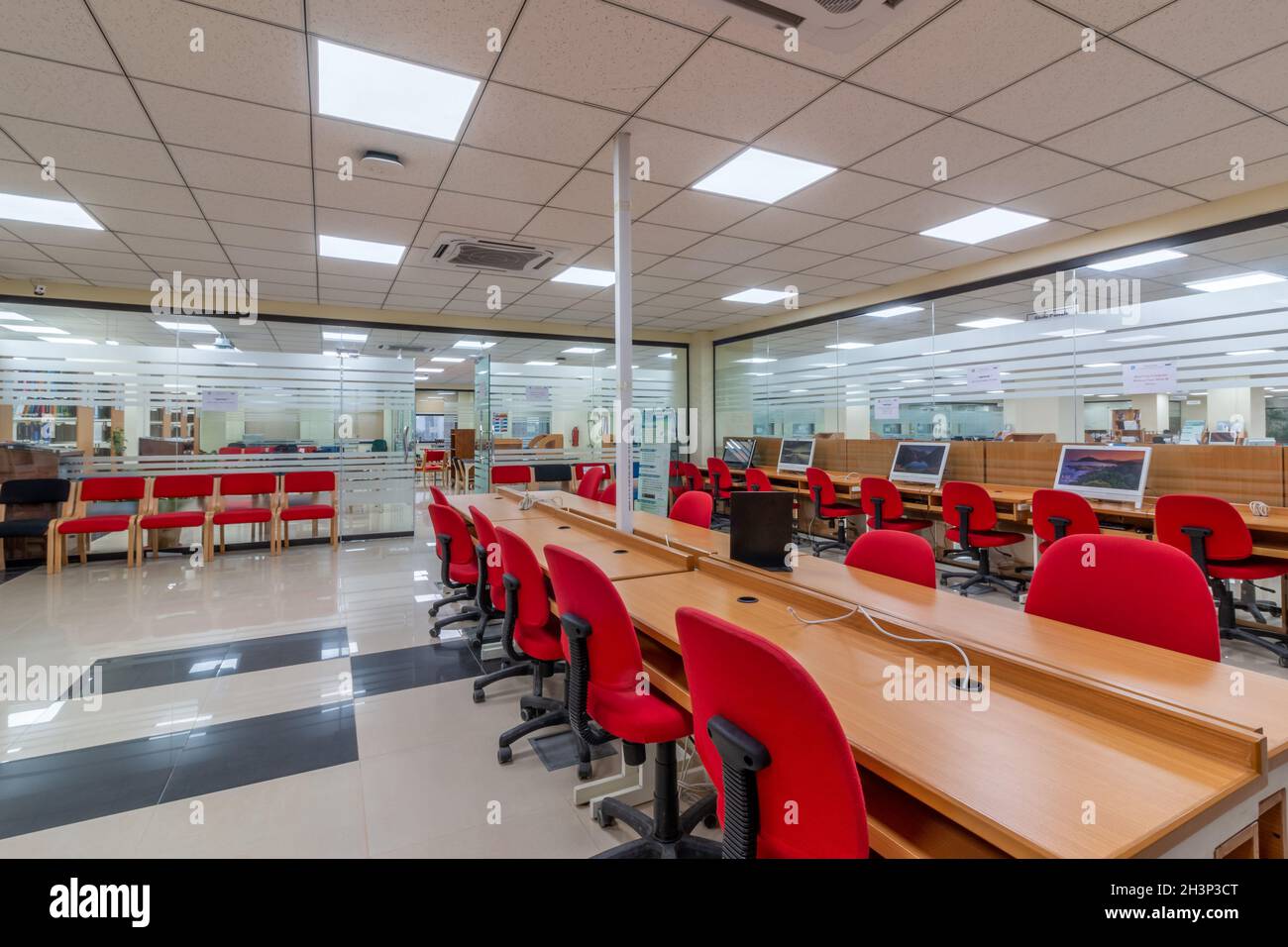 ISLAMABAD, PAKISTAN - Aug 05, 2021: An indoor library with red chairs ...