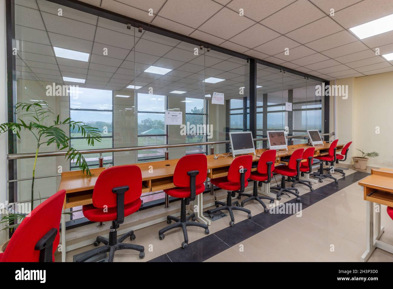 ISLAMABAD, PAKISTAN - Aug 05, 2021: An indoor library with red chairs ...