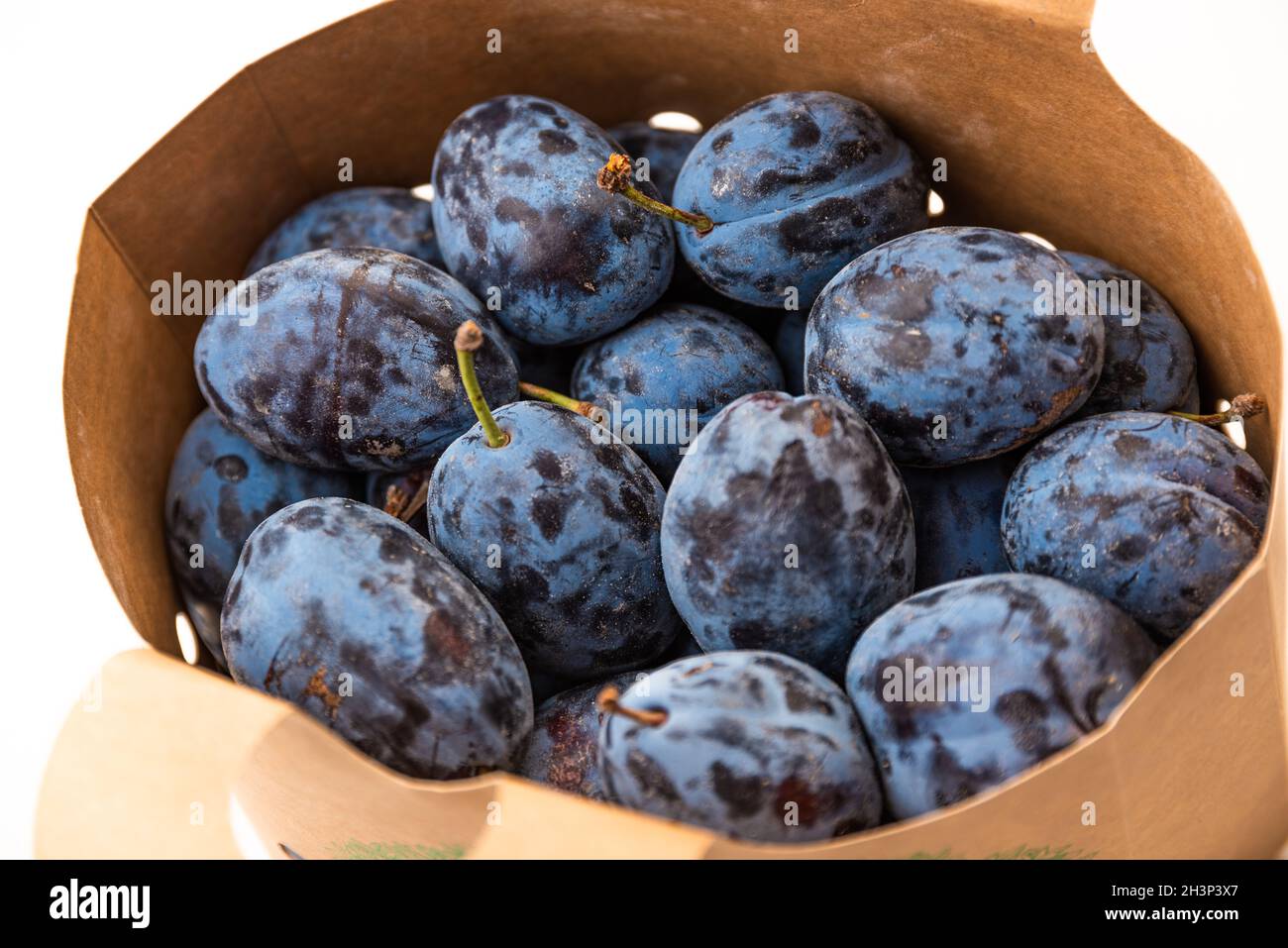 Bunch of plums in paper bag from supermarket Stock Photo - Alamy