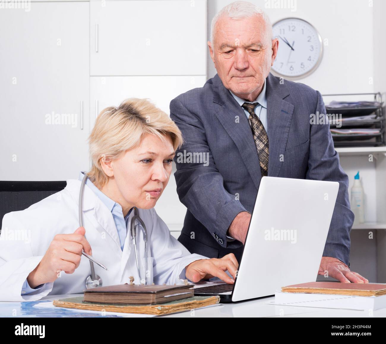 Female doctor with male client Stock Photo - Alamy