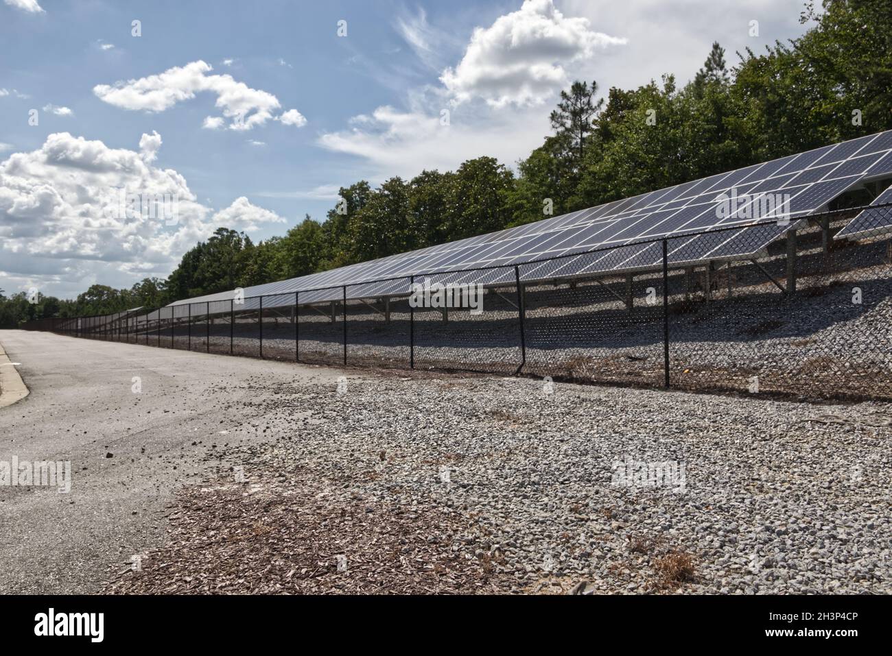 Ground view Rows of Solar panels behind a fence in Georgia Stock Photo ...