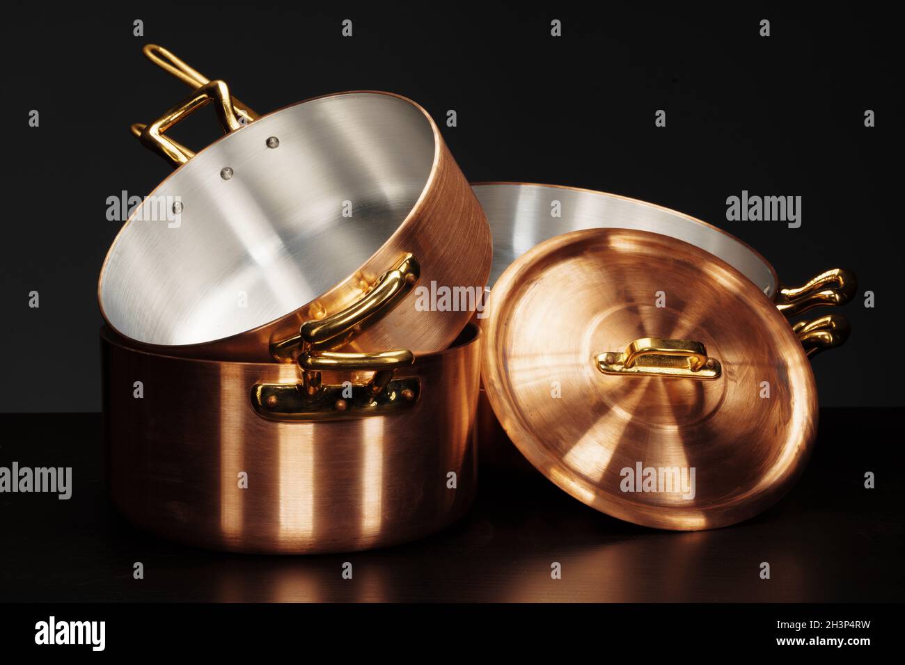Set of copper cookware over dark background Stock Photo - Alamy