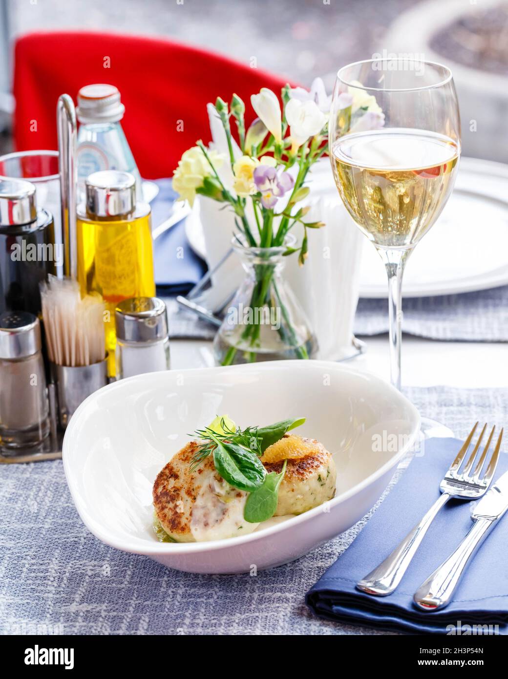 Salmon and cod fish cutlets with spinach and pike caviar with white ...