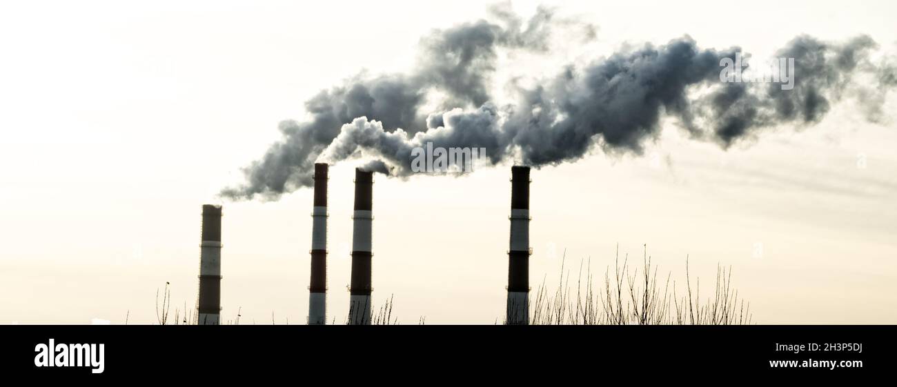 Spring, morning rising sun and smoking plant pipes Stock Photo - Alamy