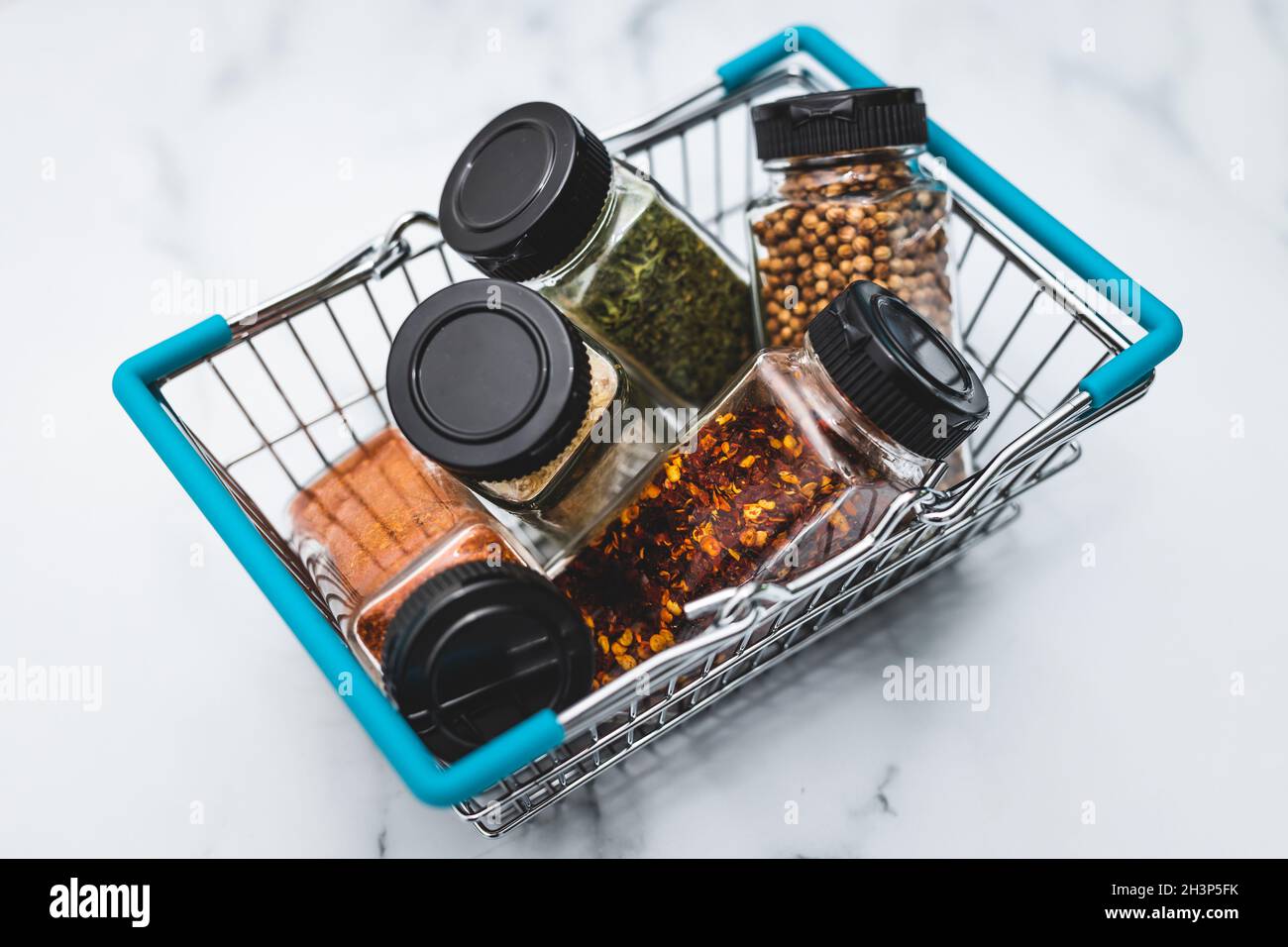 spices and seasonings in matching spice jars in ngrocery shopping ...