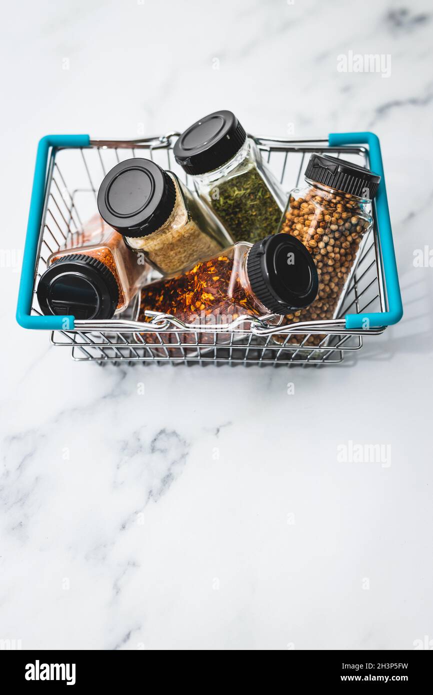 spices and seasonings in matching spice jars in ngrocery shopping ...