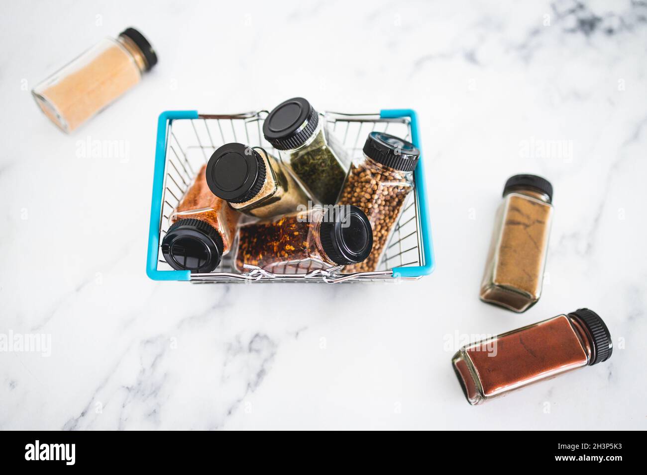 spices and seasonings in matching spice jars in ngrocery shopping ...